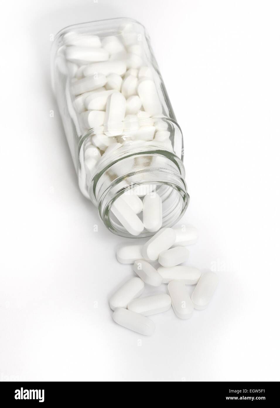 White tablets in a small glass jar close up Stock Photo - Alamy