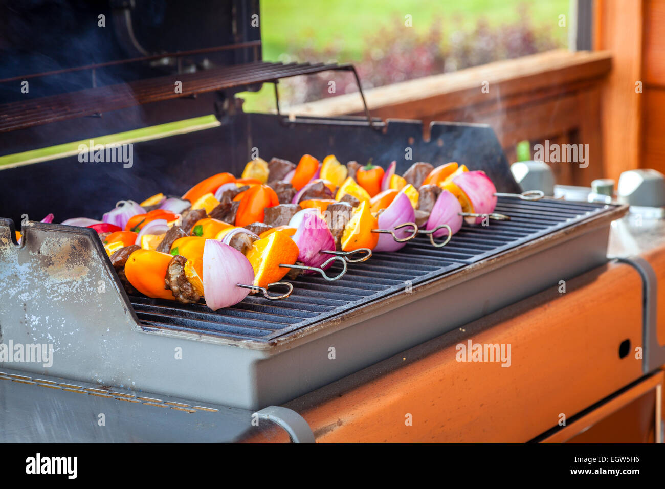 Skewers with shish kabob are cooking on a grill Stock Photo - Alamy