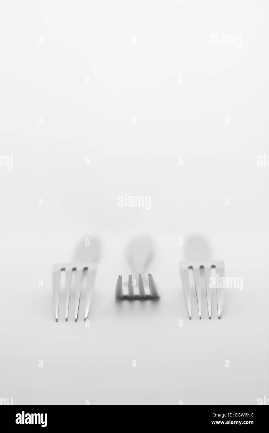 Three forks, two pointing up , one down Stock Photo - Alamy