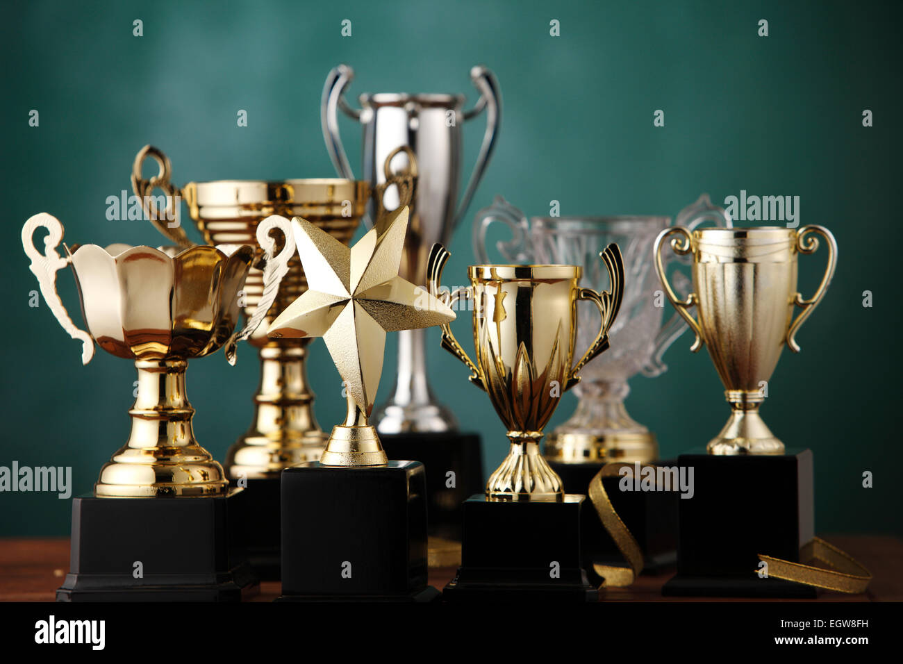 Group of the trophies on the green background Stock Photo - Alamy