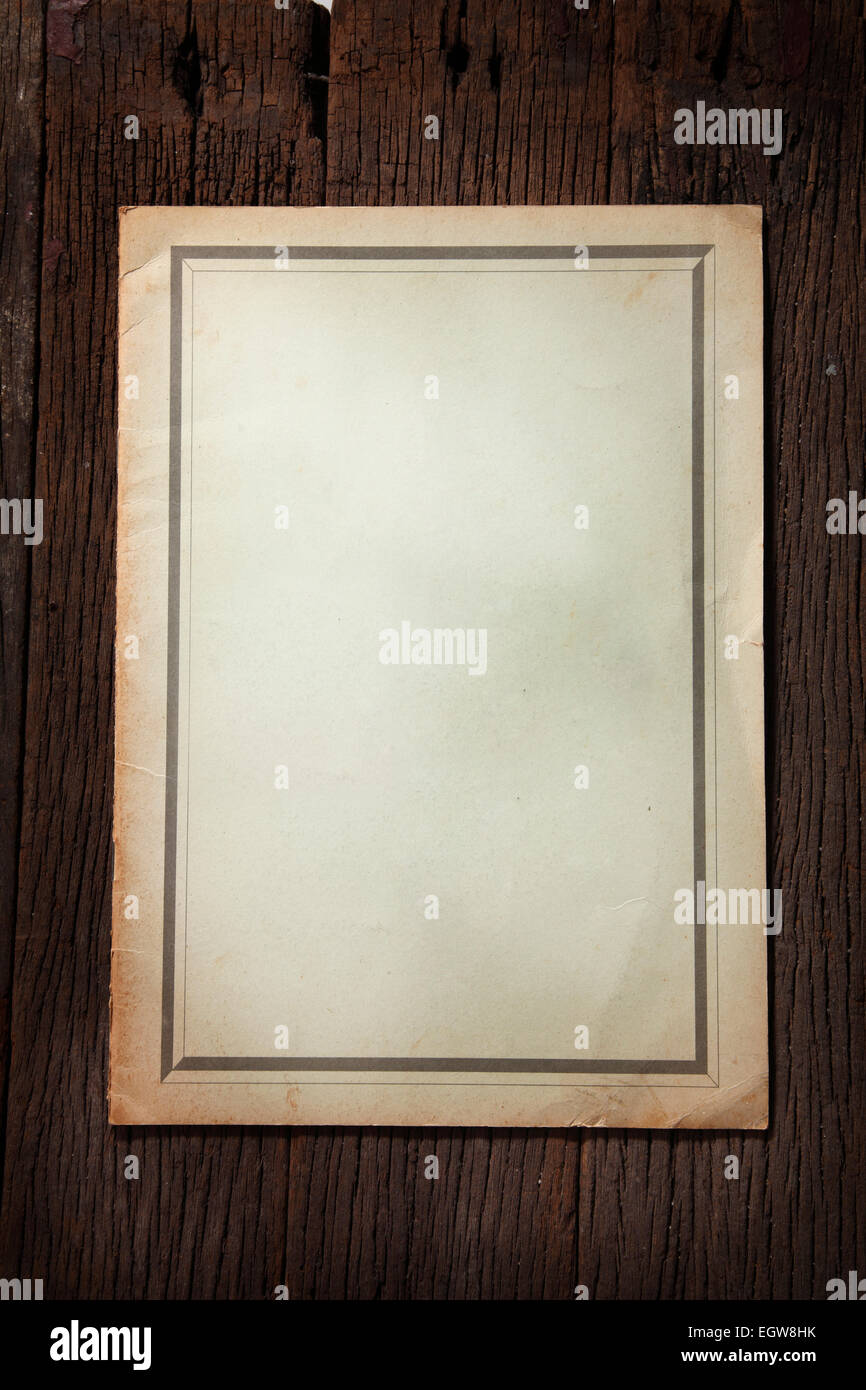 old cardboard with board stick on wood background Stock Photo - Alamy