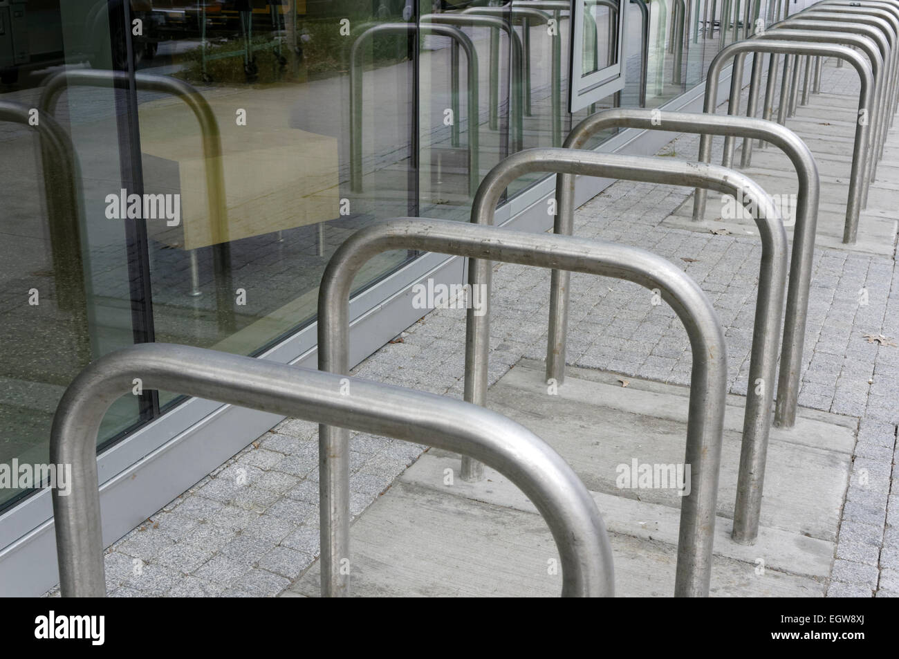 A line of empty metal bicycle racks Stock Photo - Alamy