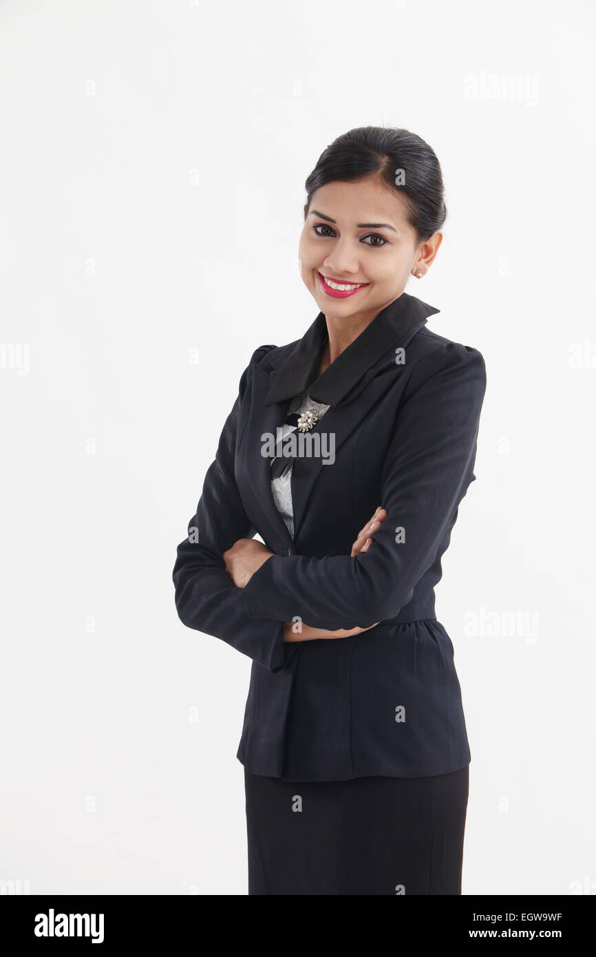 Portrait of a well-dressed young business woman with cross-armed Stock ...