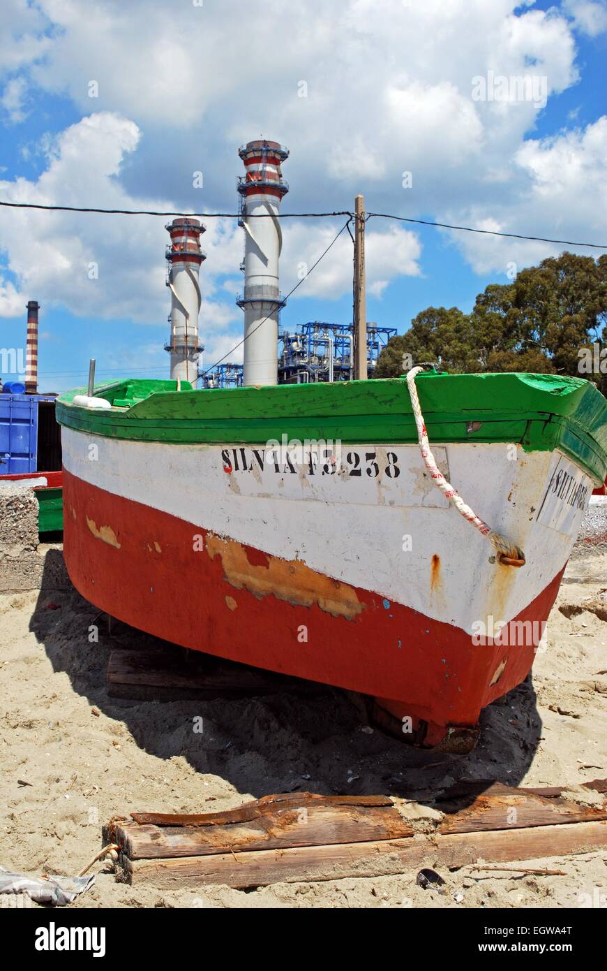 Traditional wooden red and white fishing boat with petrochemical oil ...