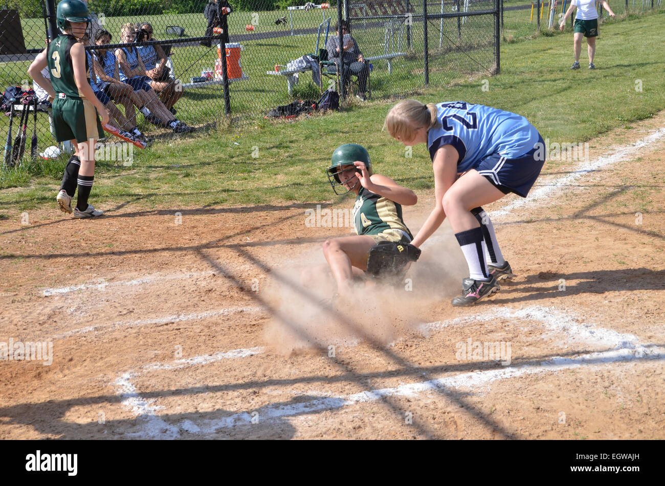 Girl tagged at home plate in a softball game Stock Photo - Alamy