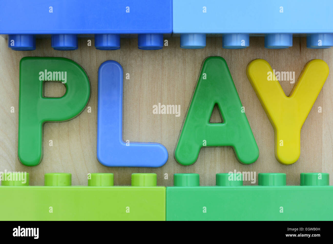 Close up of PLAY word in plastic letters surrounded by plastic toy ...