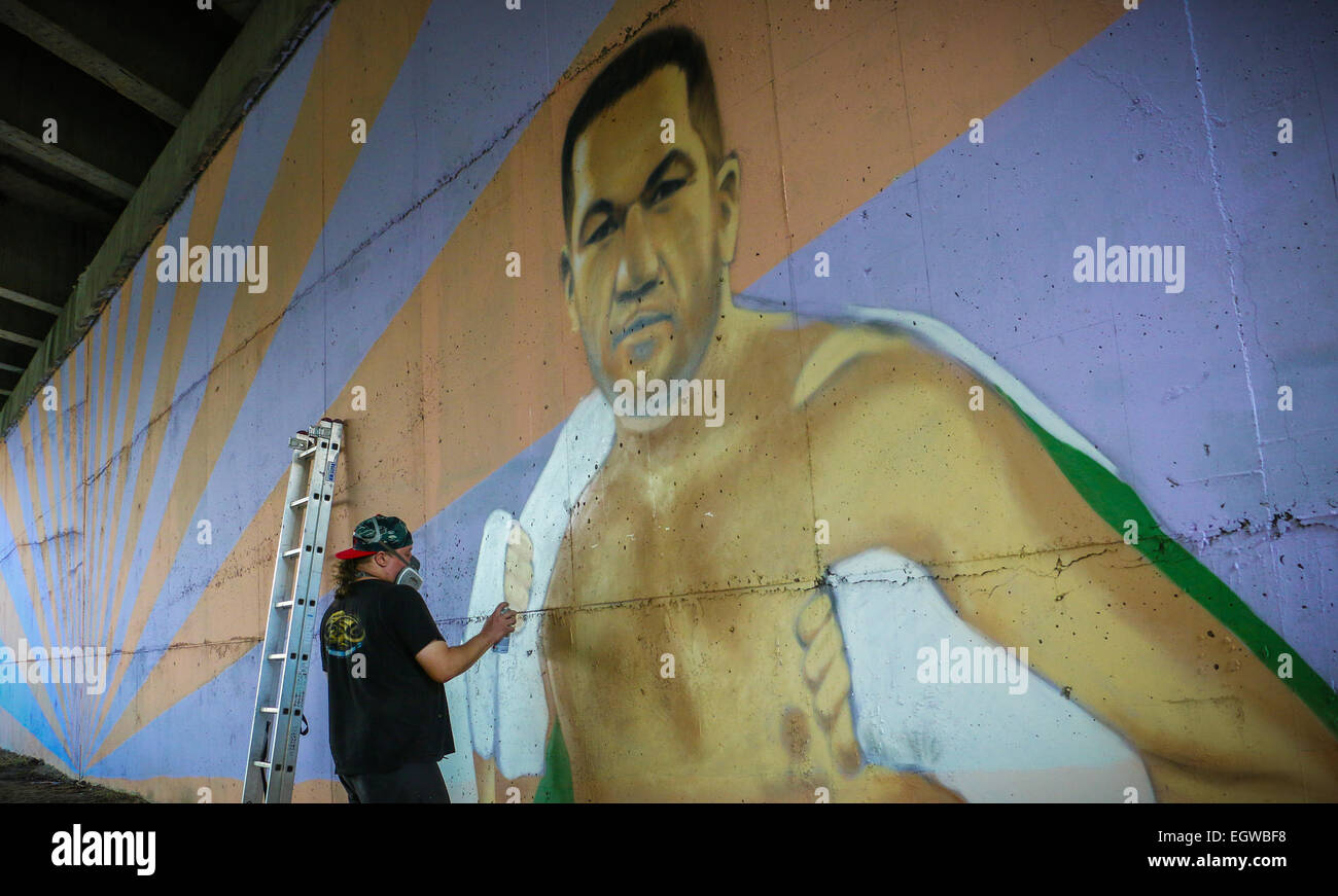 A grafitti artist paints a mural of Bulgarian boxer Kubrat Pulev, aka ...