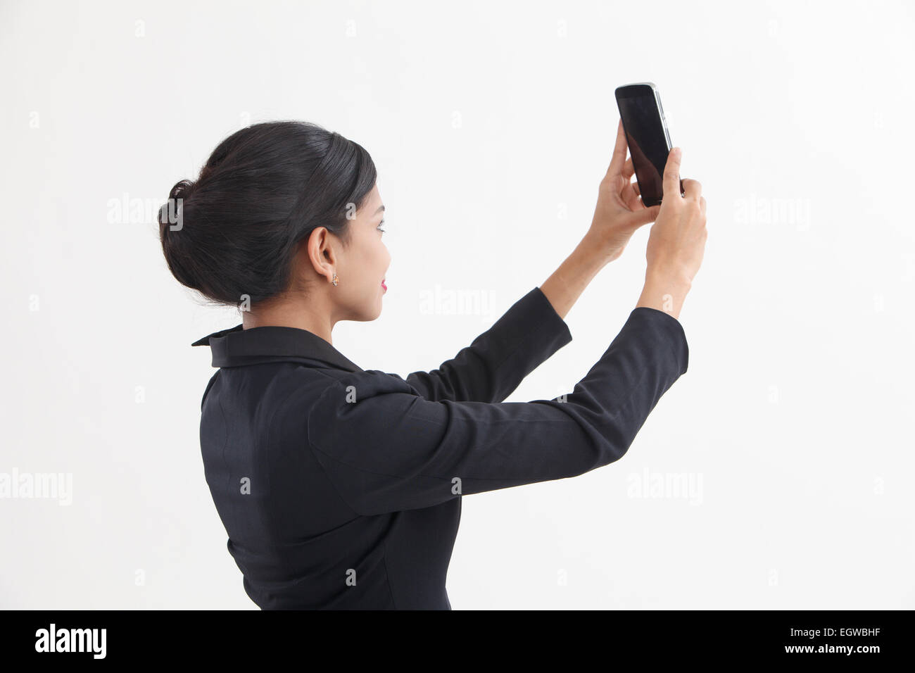 Side view business woman self portrait with smart phone Stock Photo - Alamy