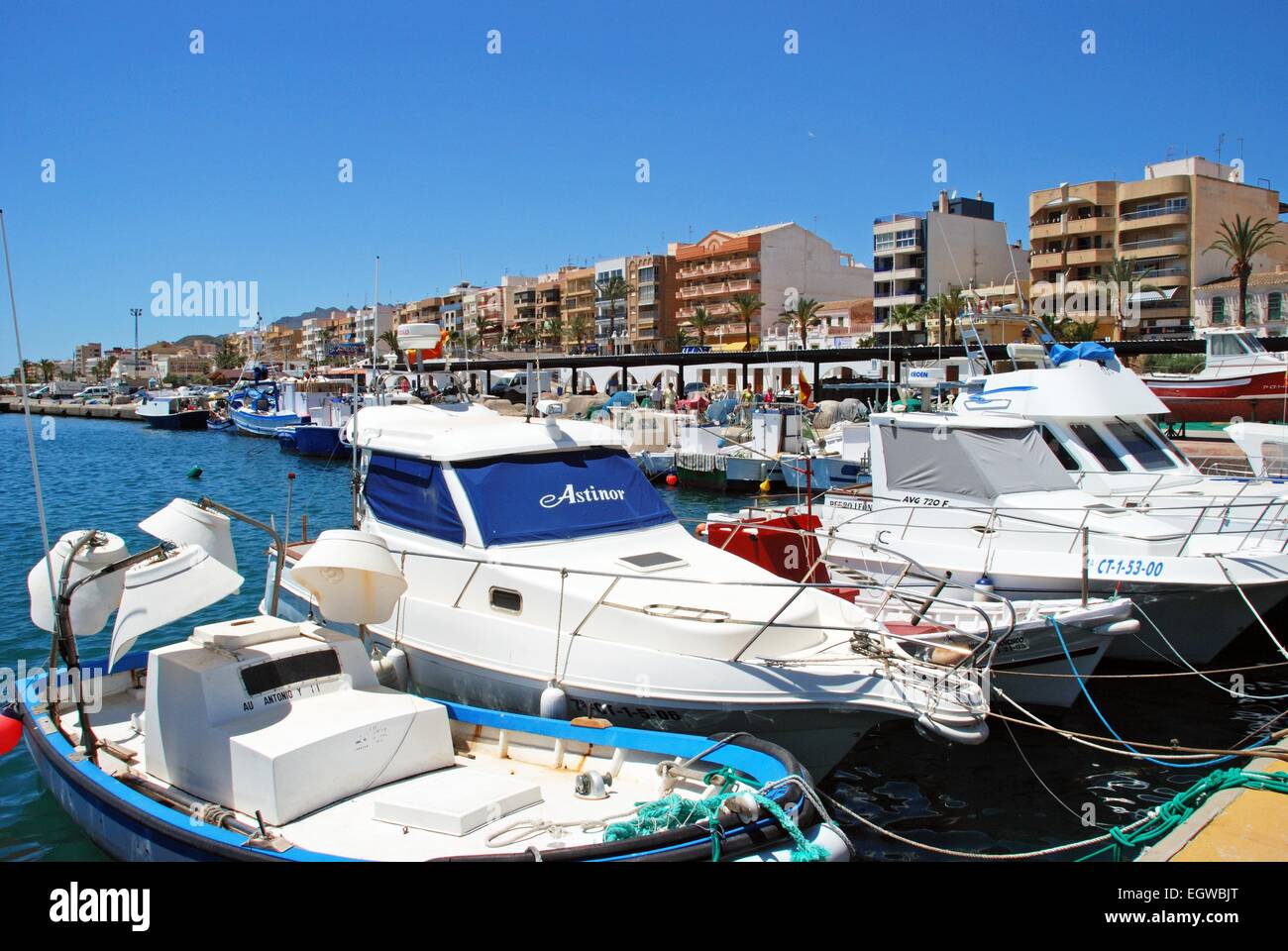 Traditional Spanish fishing boats in the harbour with waterfront ...