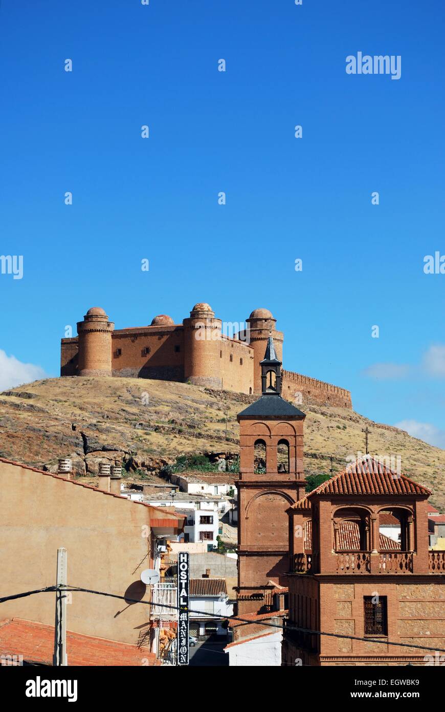 View of the castle (Castillo de La Calahorra) above the town buildings ...