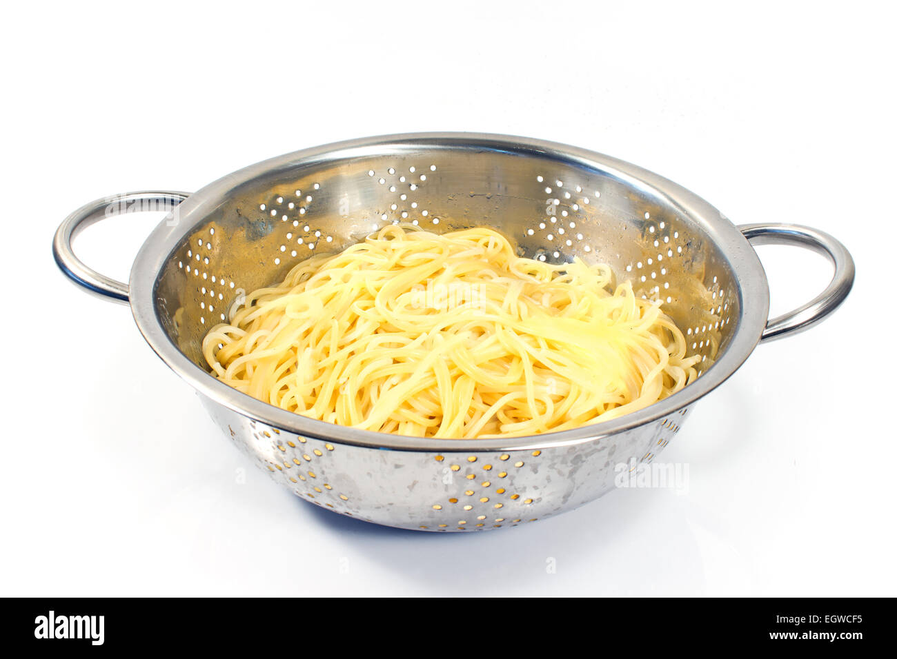 Fresh cooked spaghetti in stainless strainer isolated on white Stock ...