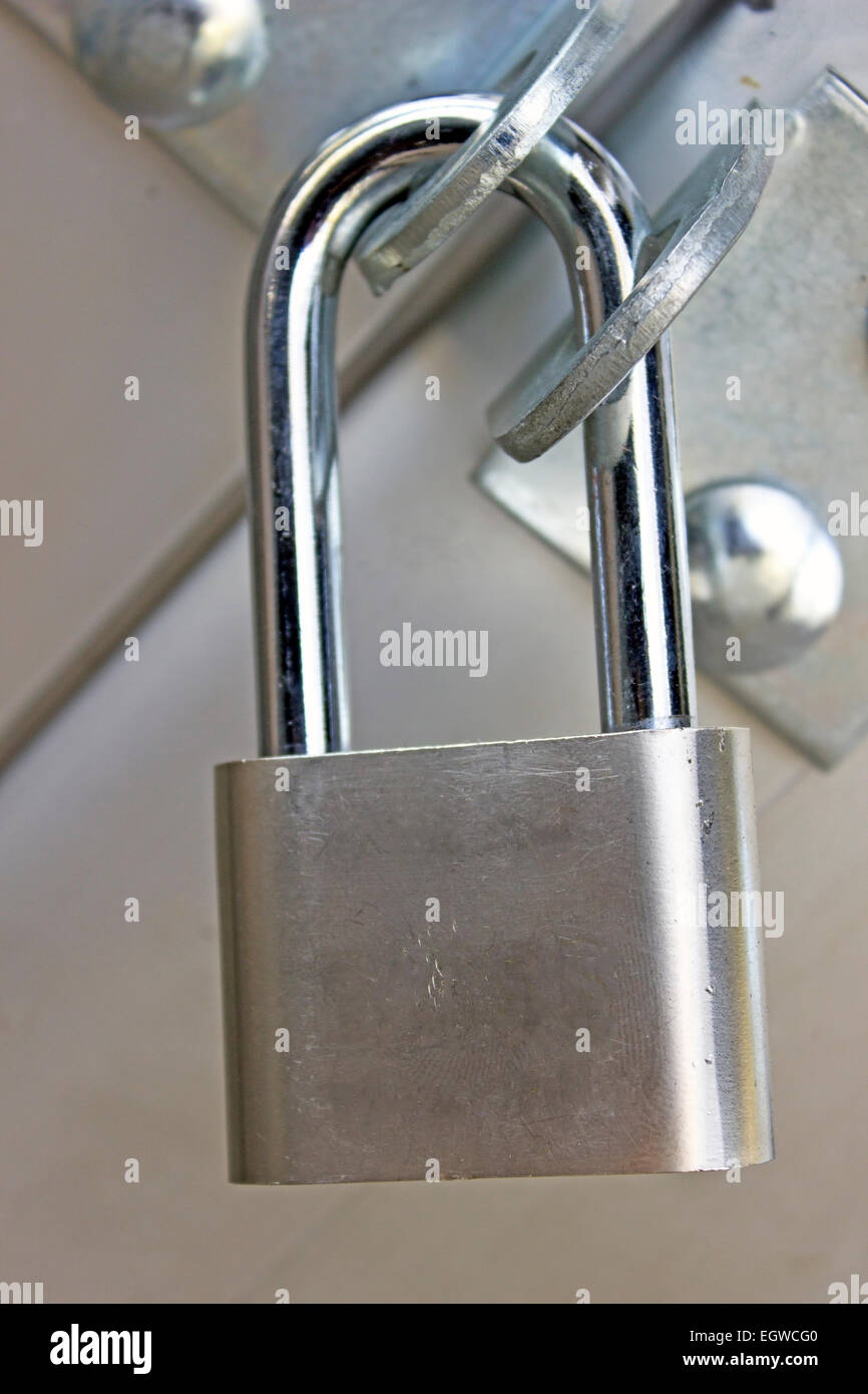 Closed padlock on a metal door Stock Photo - Alamy