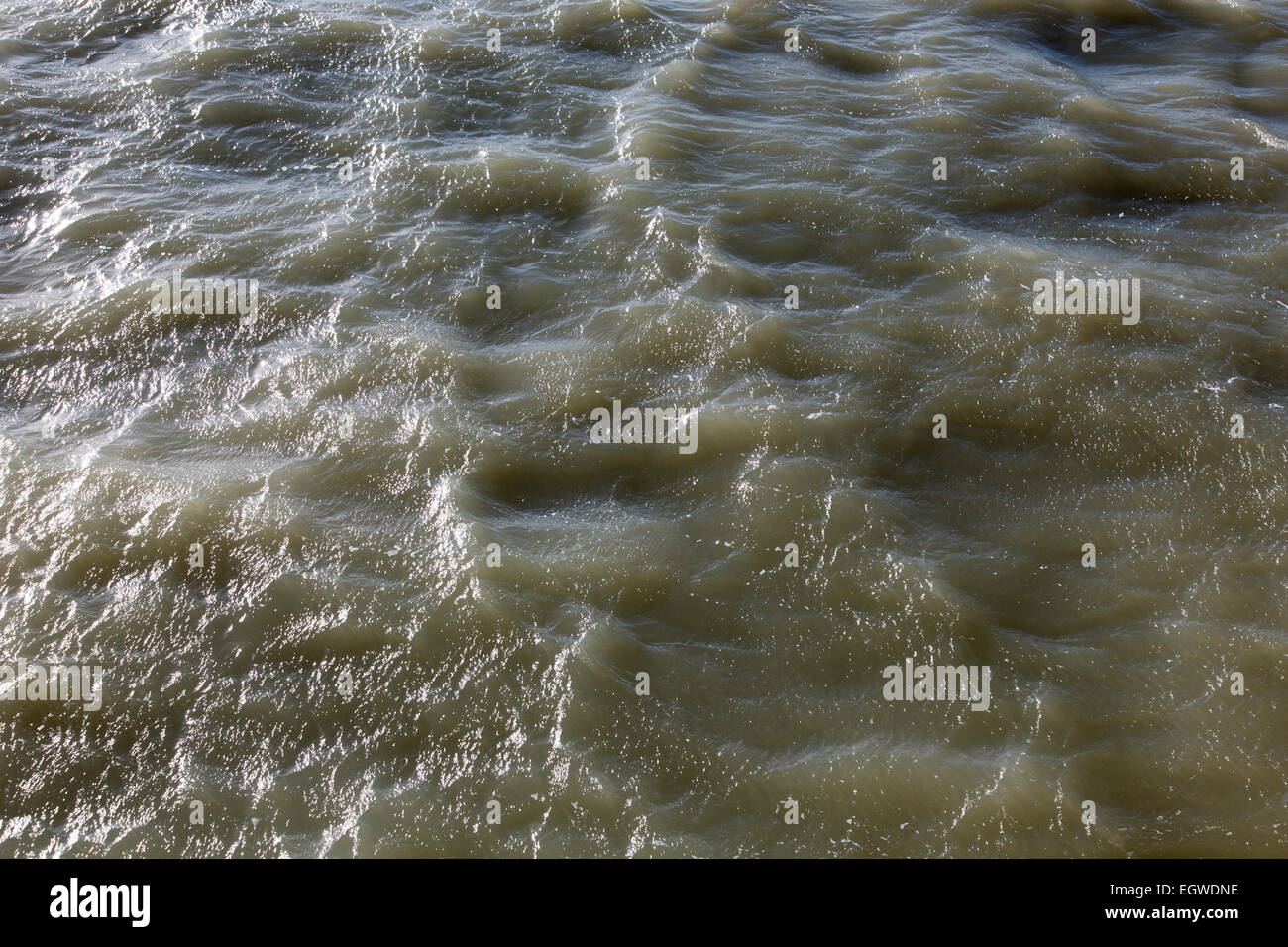 The gently rippled surface of the sea outside the harbour wall at ...
