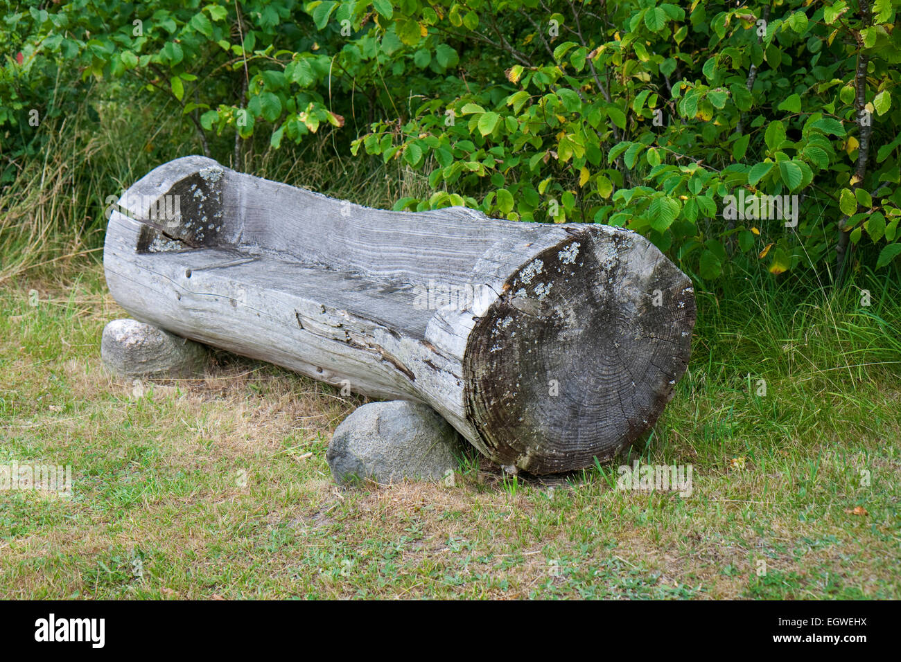 Bench made of a log Stock Photo - Alamy
