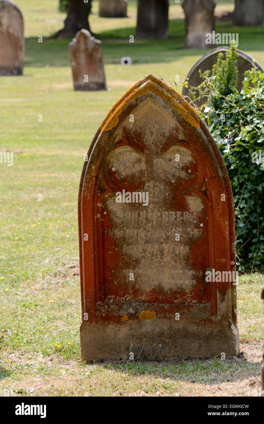 Limestone gravestone stained red and yellow by lichen at Bedford ...