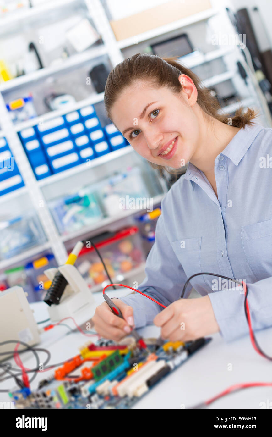 girl with a tester and a printed circuit board Stock Photo - Alamy