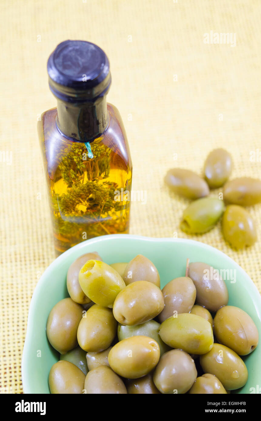 Fresh green olives and a bottle of virgin olive oil Stock Photo - Alamy