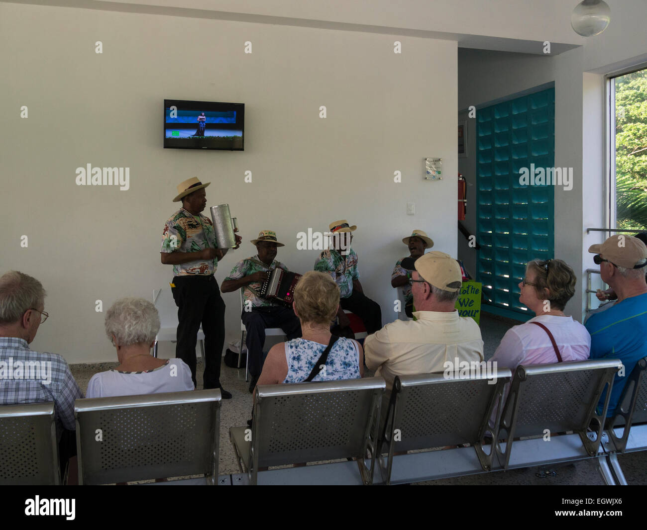 Four Dominican men playing popular merengue music to listening tourists ...