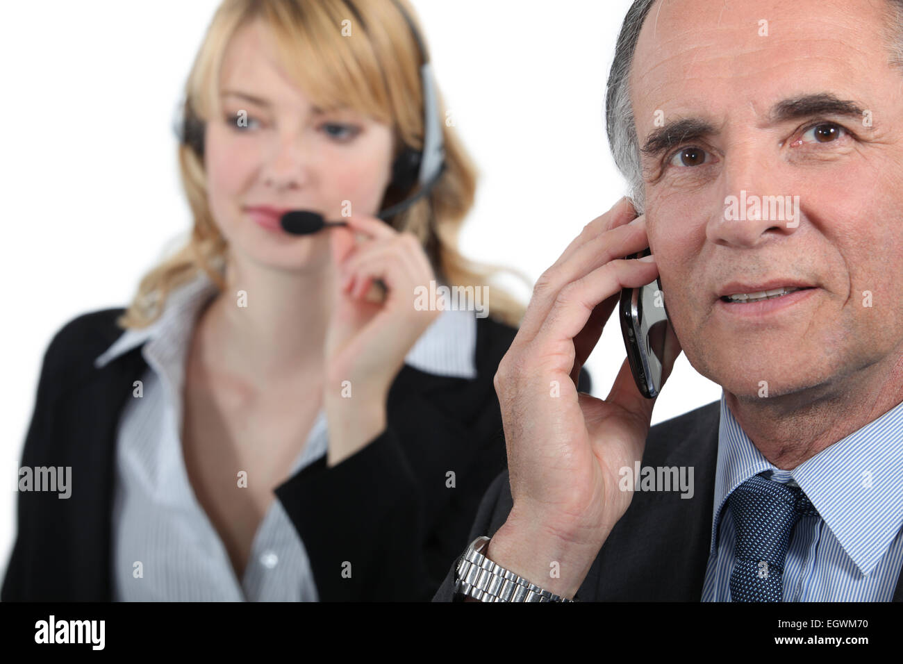 Boss and assistant making calls to customers Stock Photo - Alamy