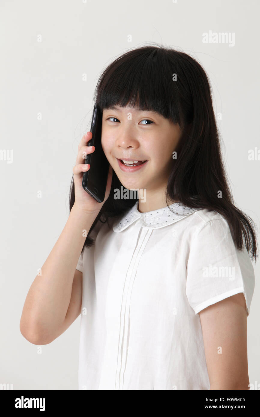 chinese girl talking with cellphone looking at camera Stock Photo - Alamy