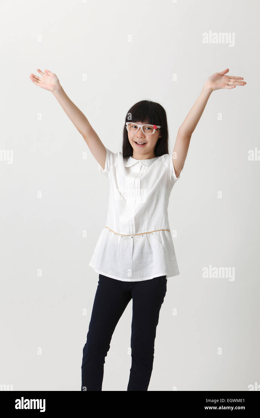 happy girl standing raising her arm Stock Photo - Alamy
