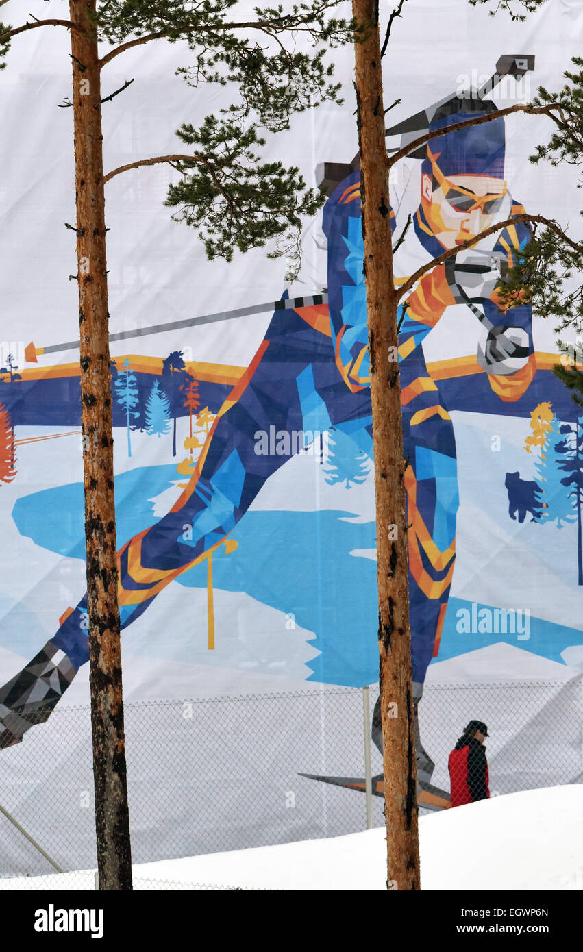 A pedestrian is passing a huge poster showing a biathlete in ...