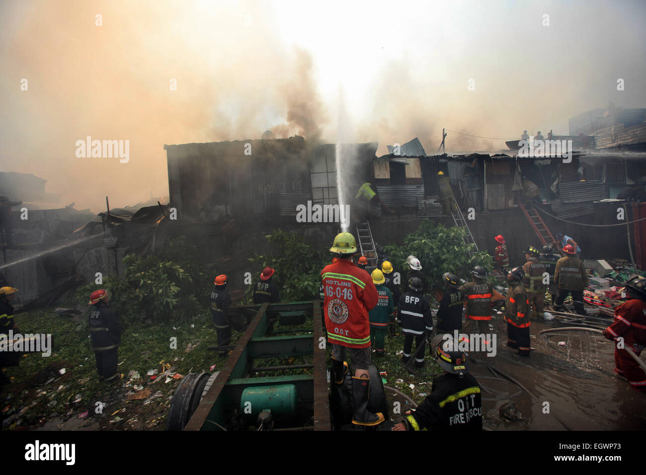 Manila, Philippines. 3rd Mar, 2015. Firefighters try to put out a fire ...