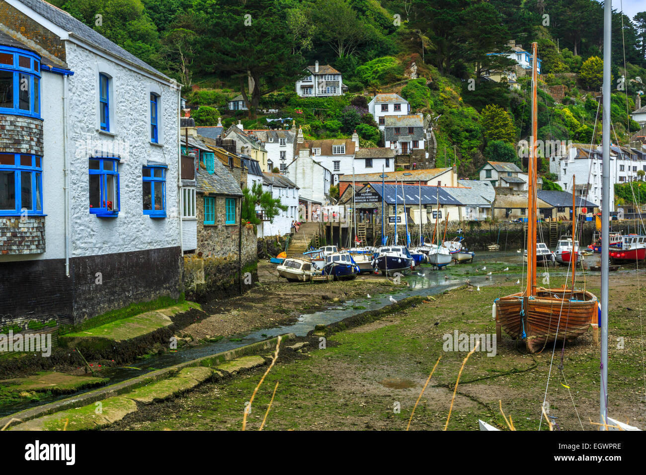 Boats and cottages around the harbour at Polperro in Cornwall Stock ...