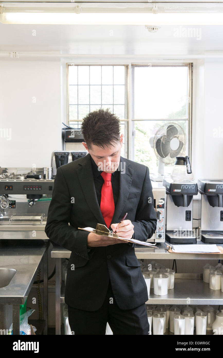 a hotel worker checks and manages various aspects of day to day hotel ...