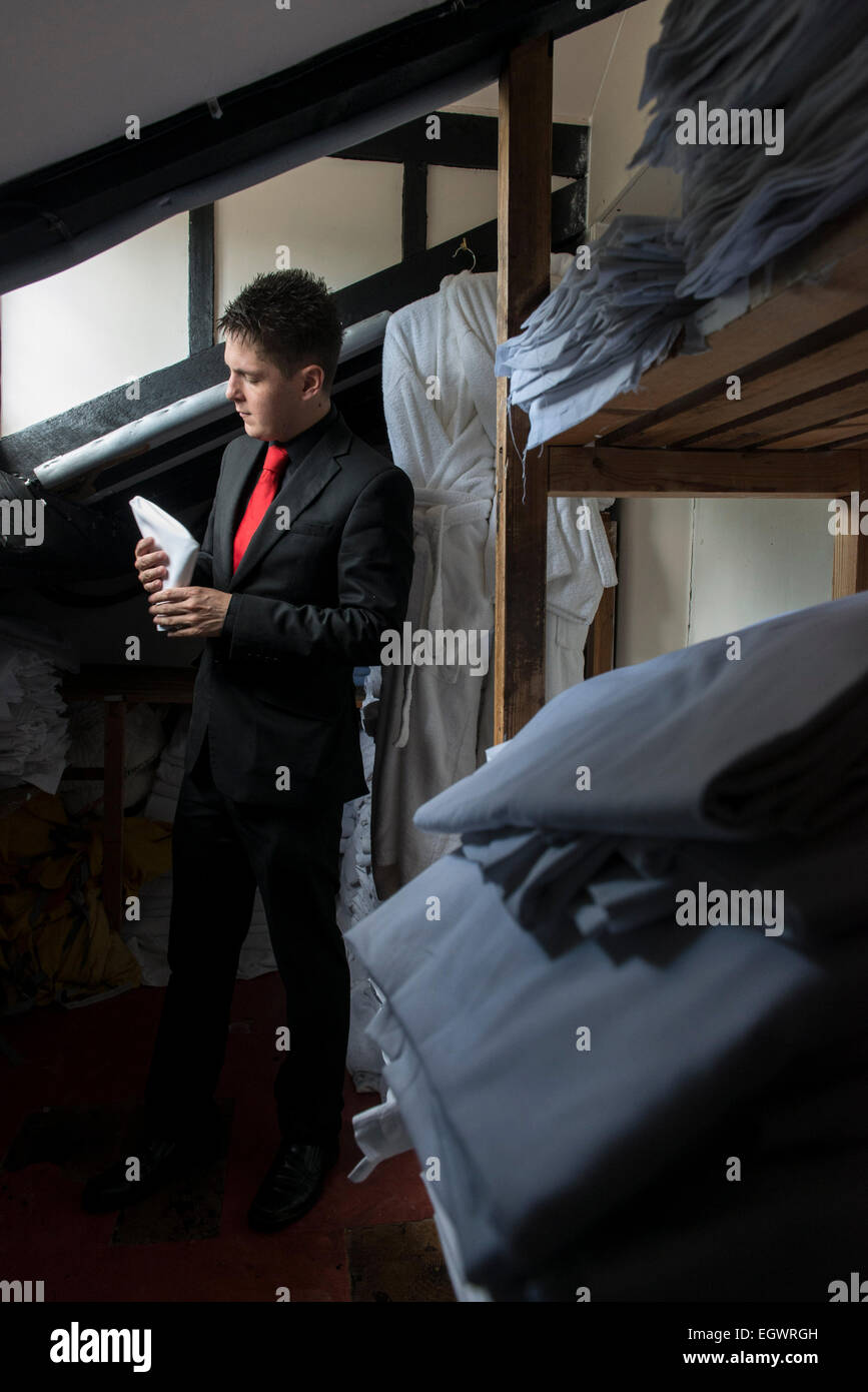a hotel worker checks and manages various aspects of day to day hotel ...