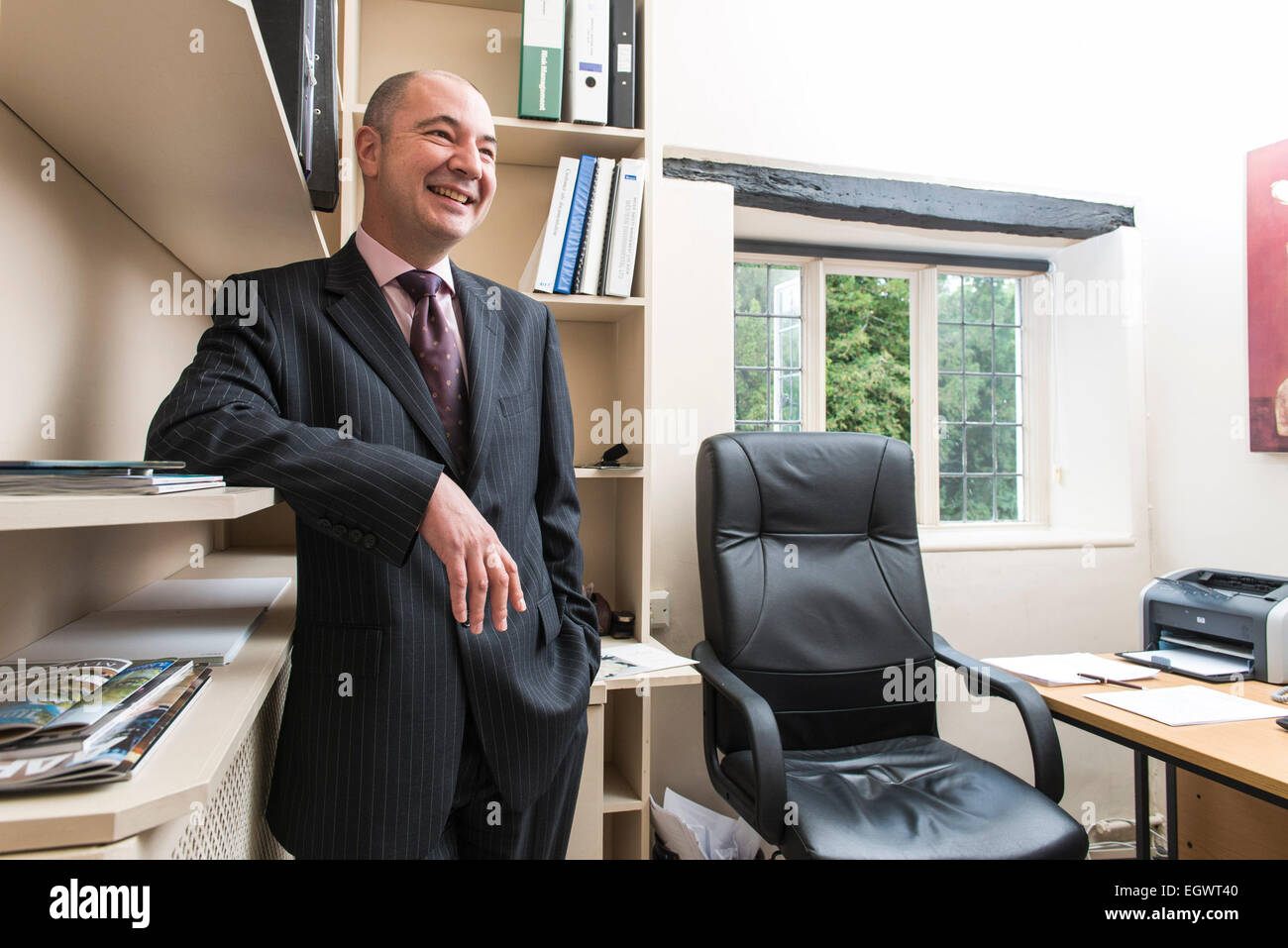 a professional businessman manager in his business suit stands in his ...