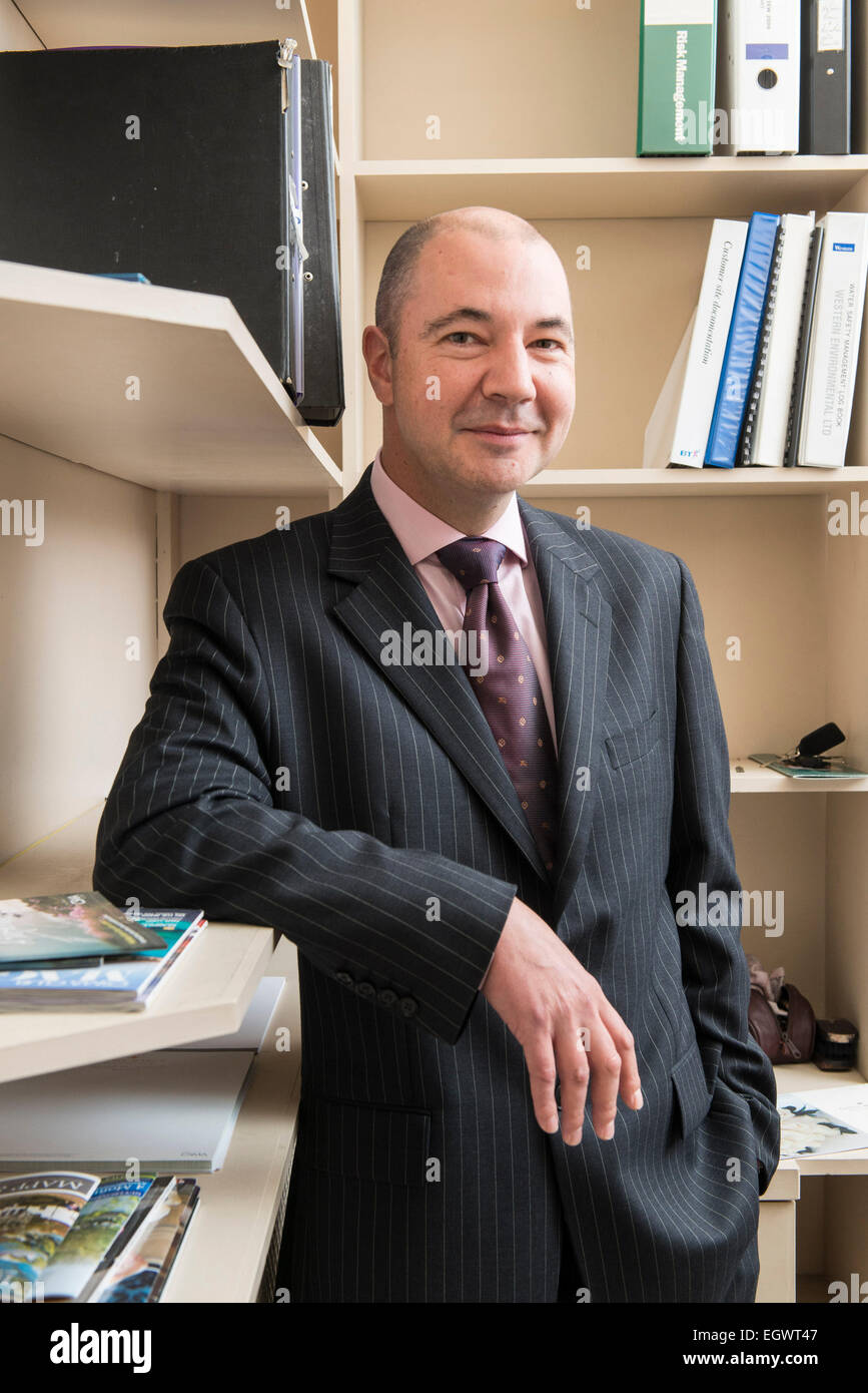 a professional businessman manager in his business suit stands in his ... a professional businessman manager in his business suit stands in his ...