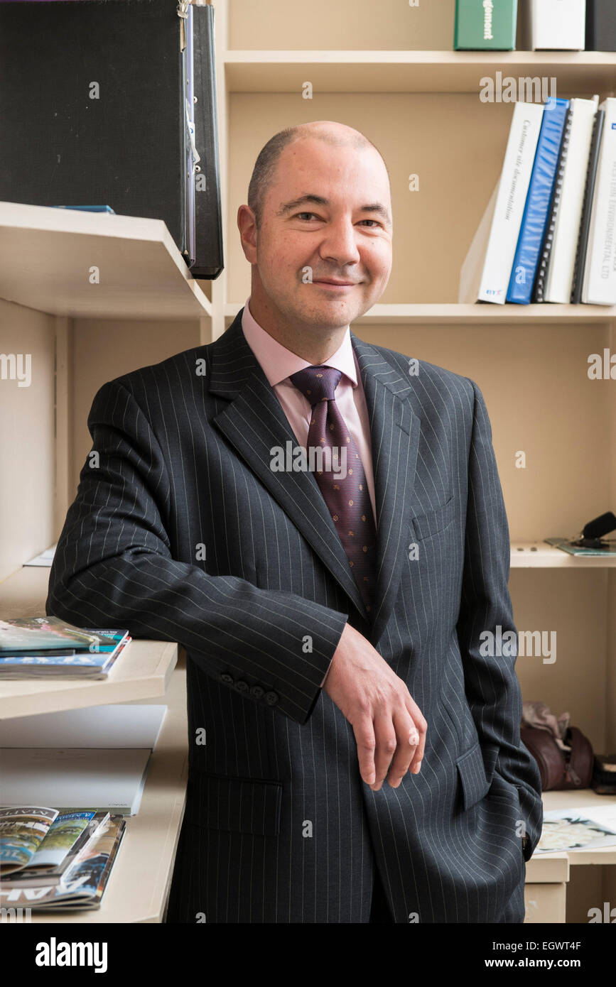 a professional businessman manager in his business suit stands in his ...