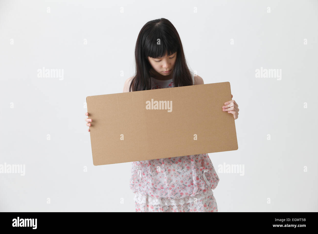 chinese girl holding and looking at brown message board Stock Photo - Alamy