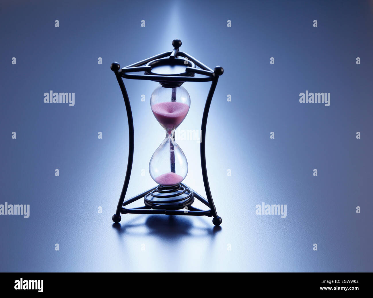 hour glass on the blue background Stock Photo - Alamy
