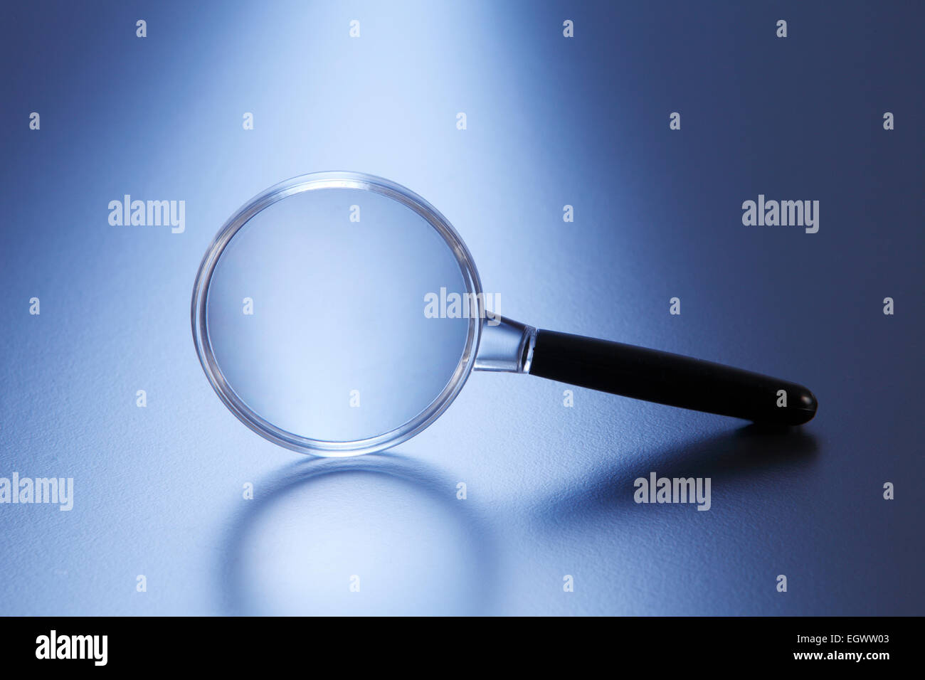 close up of the magnifier on the blue background Stock Photo - Alamy