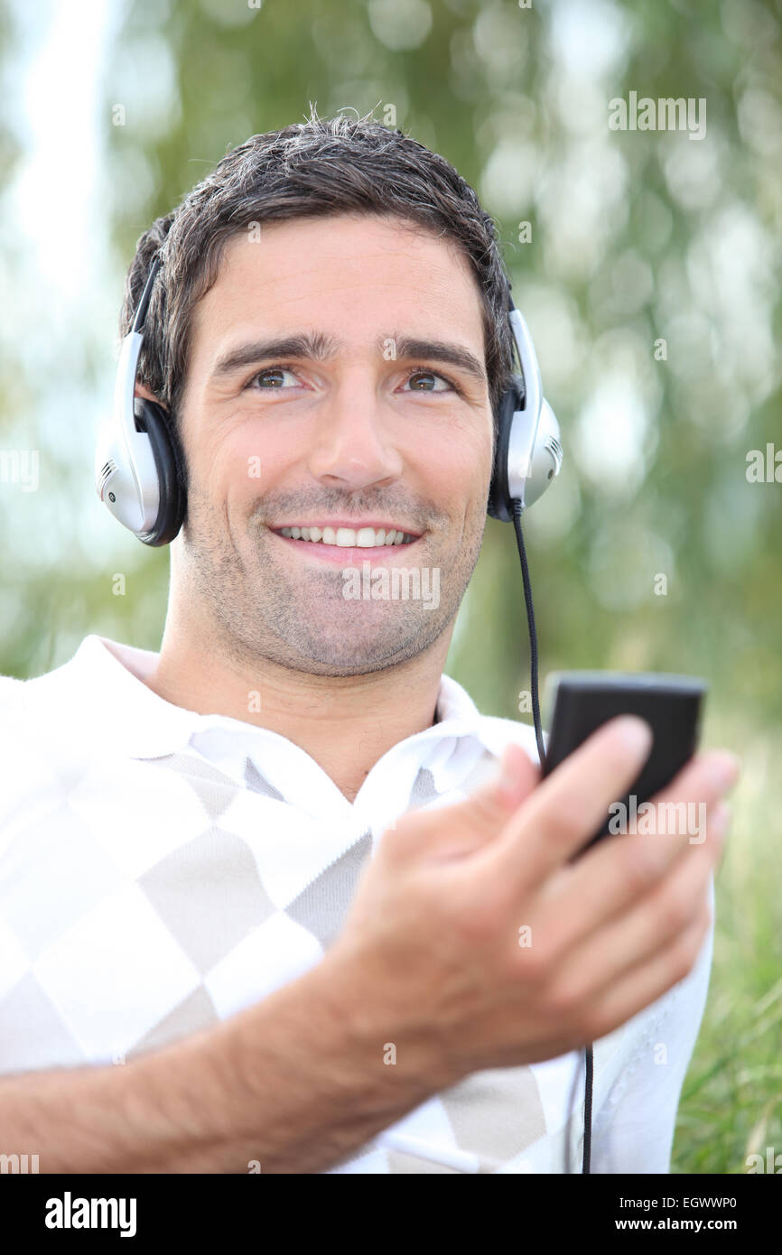 Young man listening to music Stock Photo - Alamy