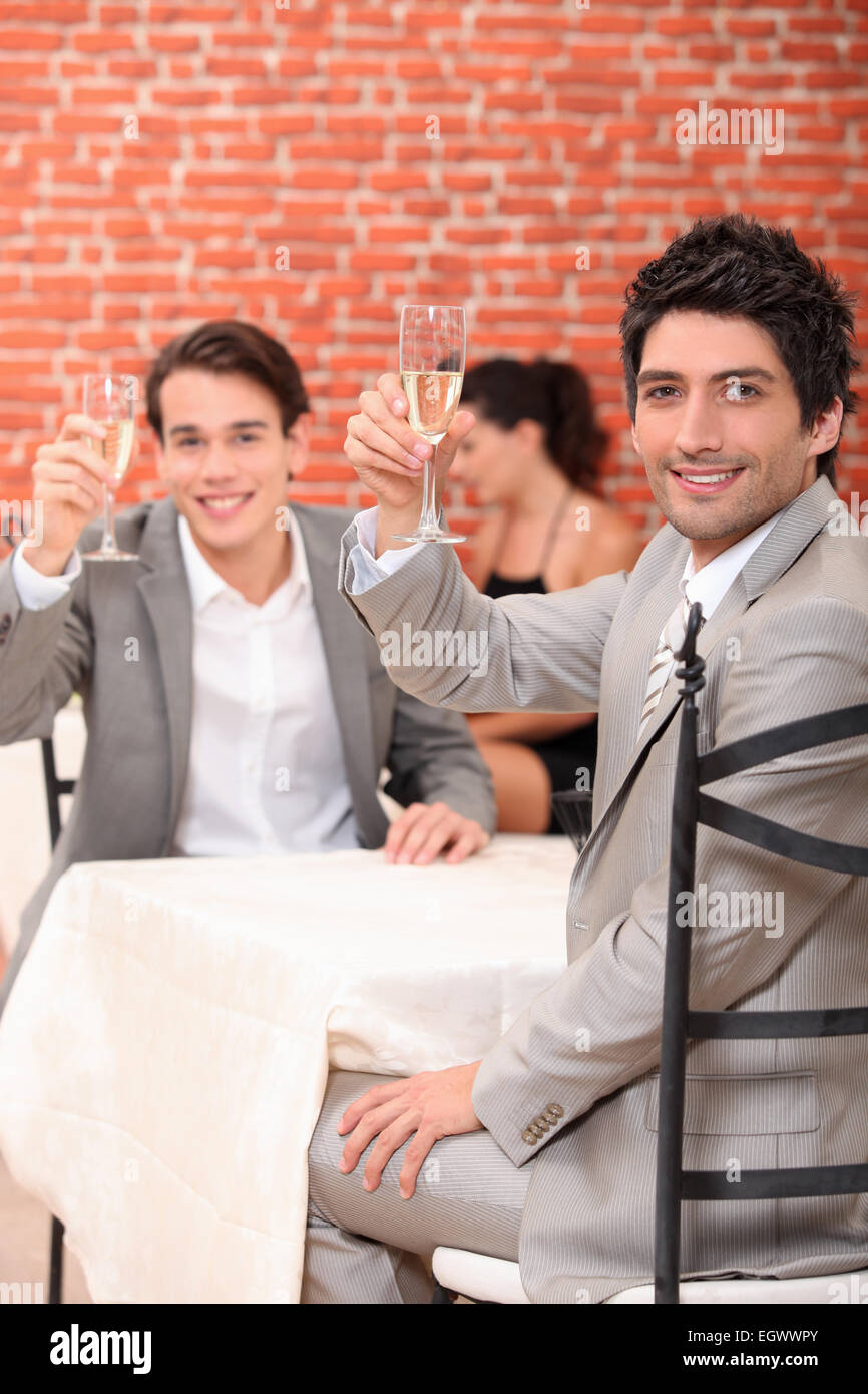 Friends toasting in restaurant Stock Photo - Alamy