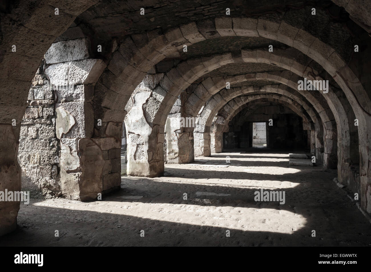 Interior of empty dark corridor with arcs. Ruins of Ancient city Smyrna ...