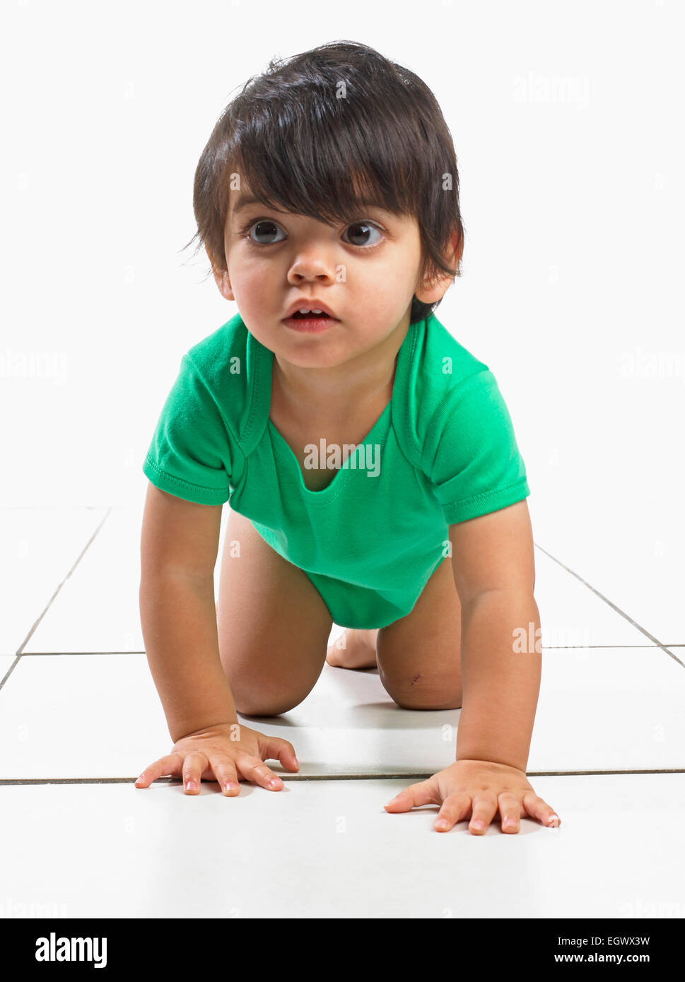 Baby boy (16 months) crawling forward Stock Photo - Alamy