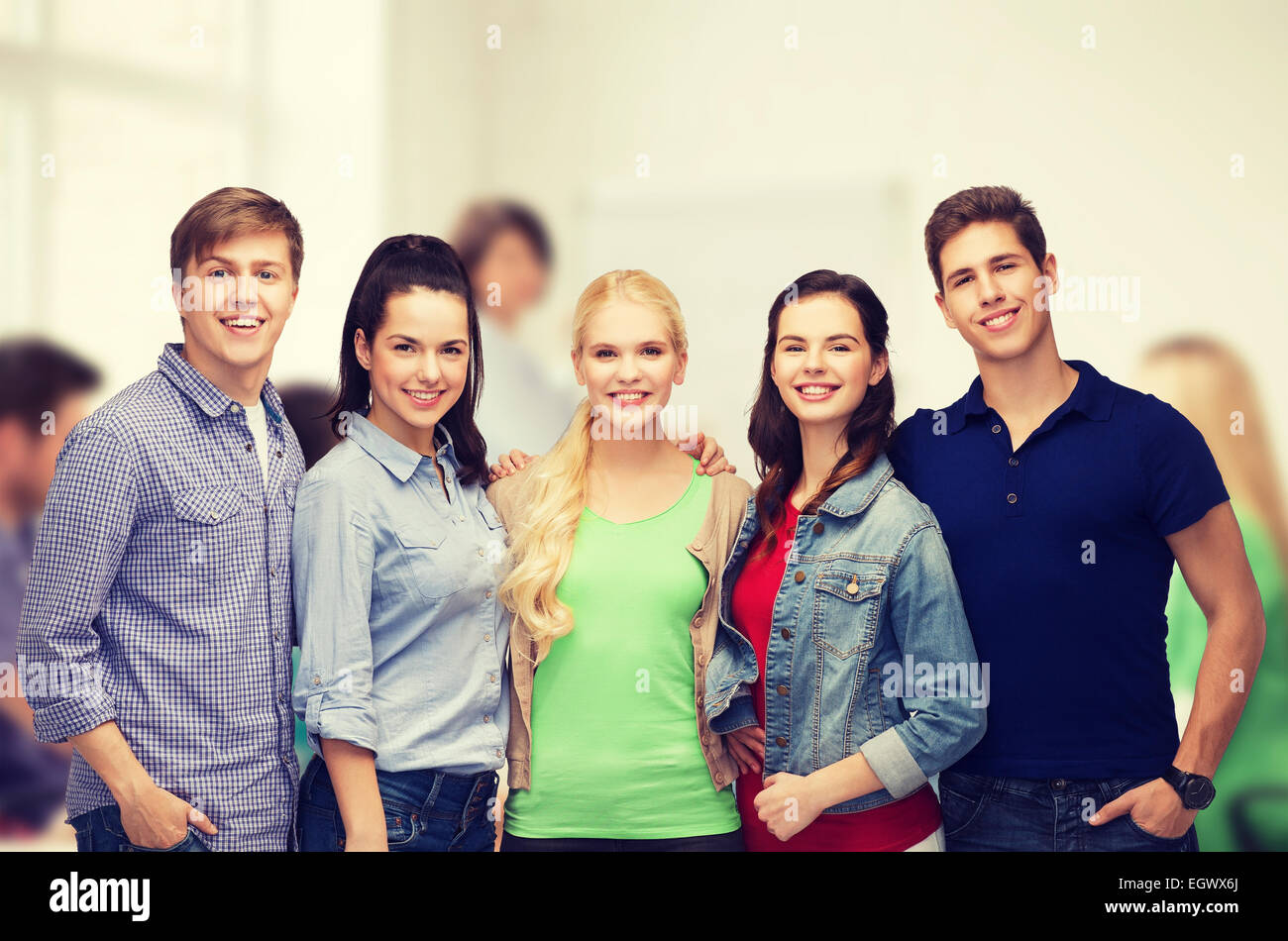 group of standing smiling students Stock Photo - Alamy