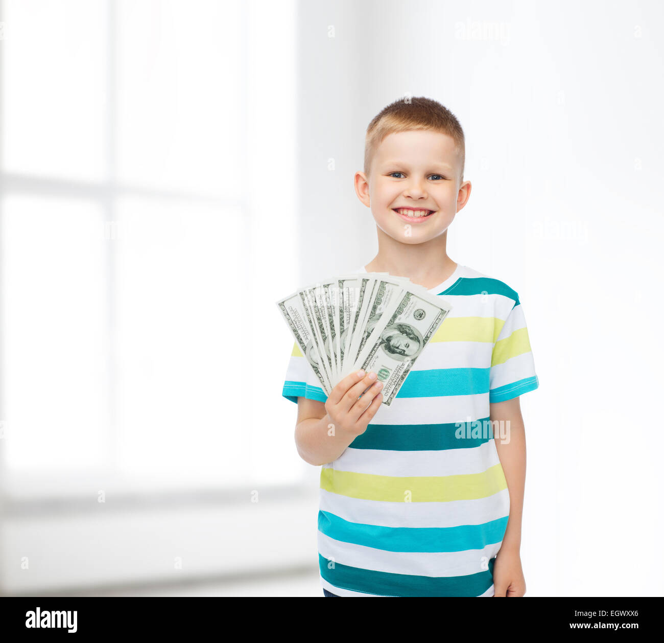 smiling boy holding dollar cash money in his hand Stock Photo - Alamy