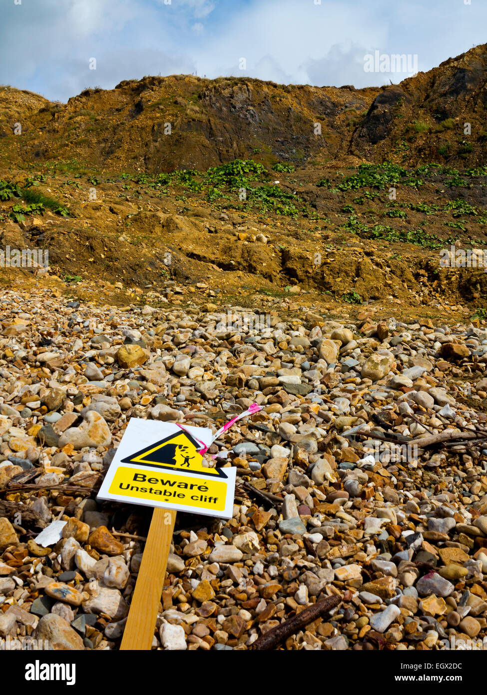 Broken Beware Unstable Cliff sign below sandstone cliffs and beach at ...
