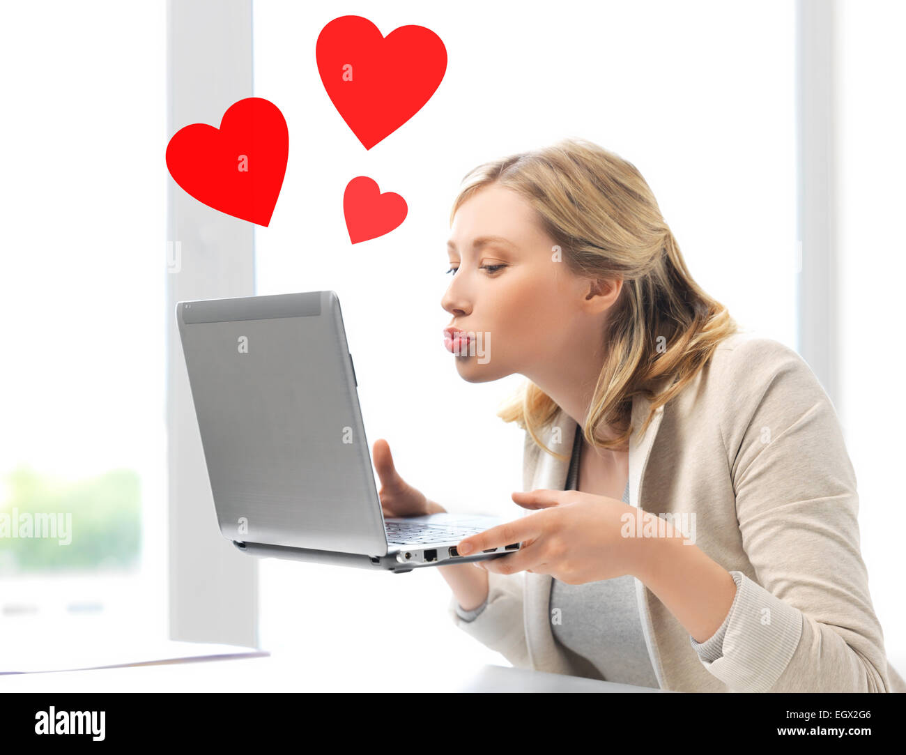 woman sending kisses with laptop computer Stock Photo - Alamy