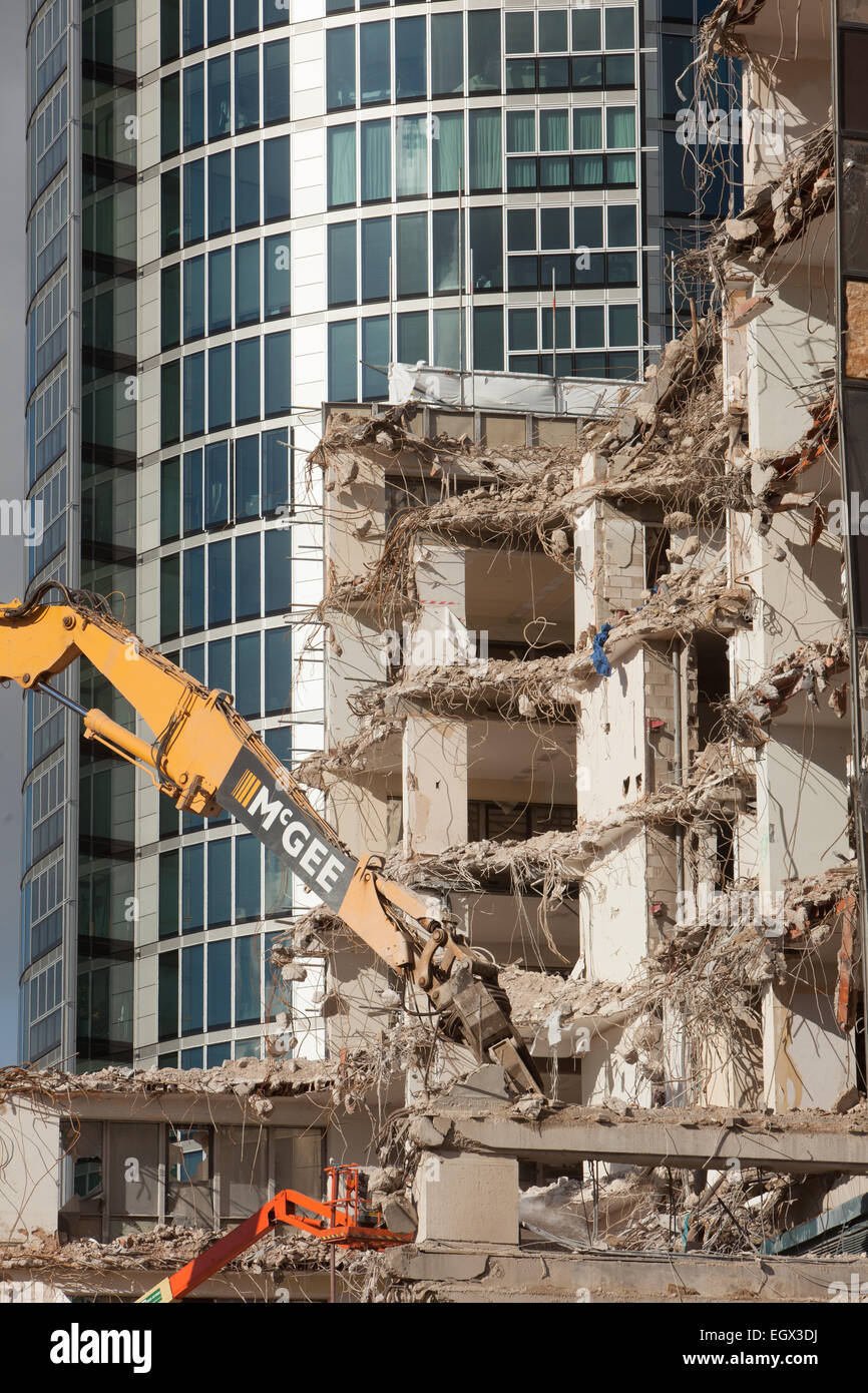 Demolition and Construction with mechanical digger in foreground Stock ...