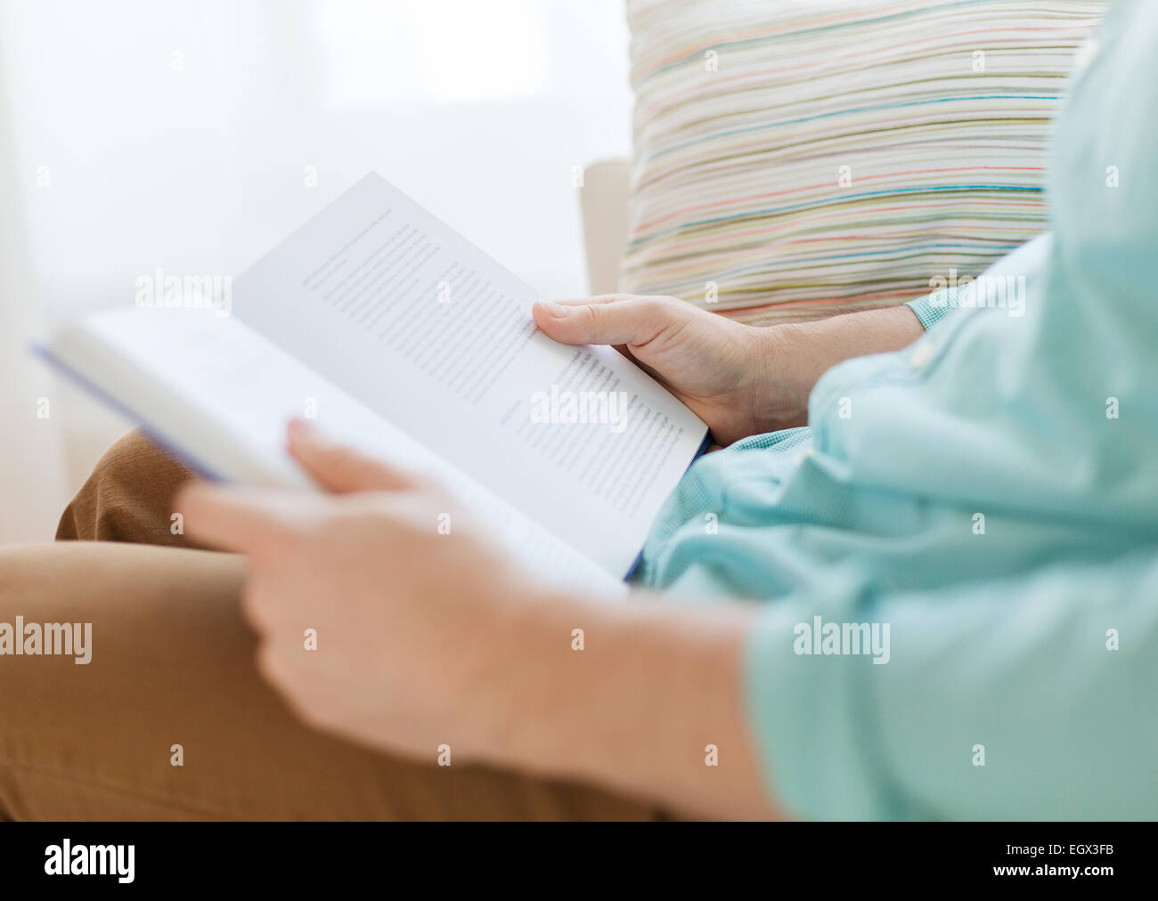 close up of man reading book at home Stock Photo - Alamy