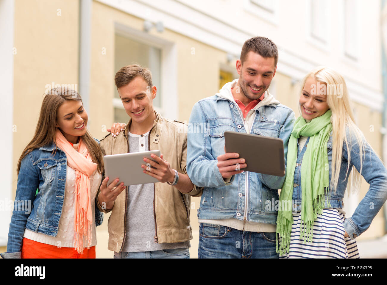 group of smiling friends with tablet pc computers Stock Photo - Alamy