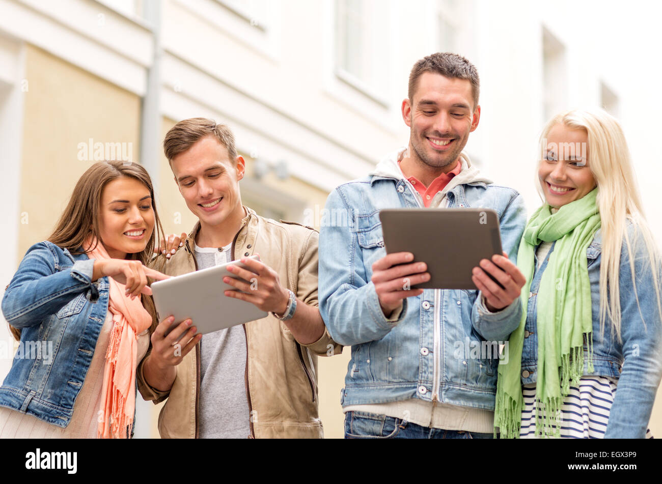 group of smiling friends with tablet pc computers Stock Photo - Alamy