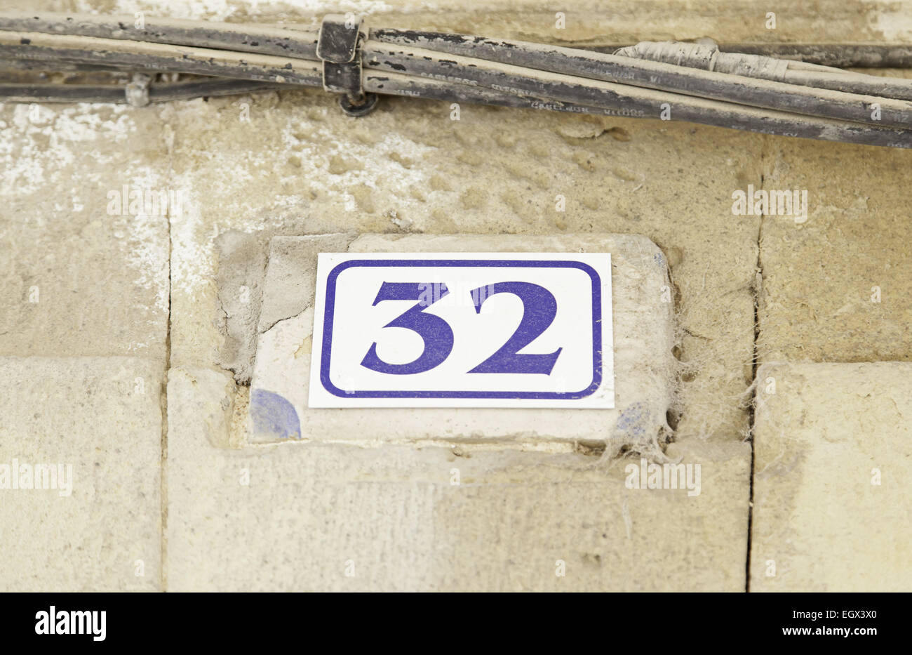 Number thirty-two on the wall of a house, number of information, even ...