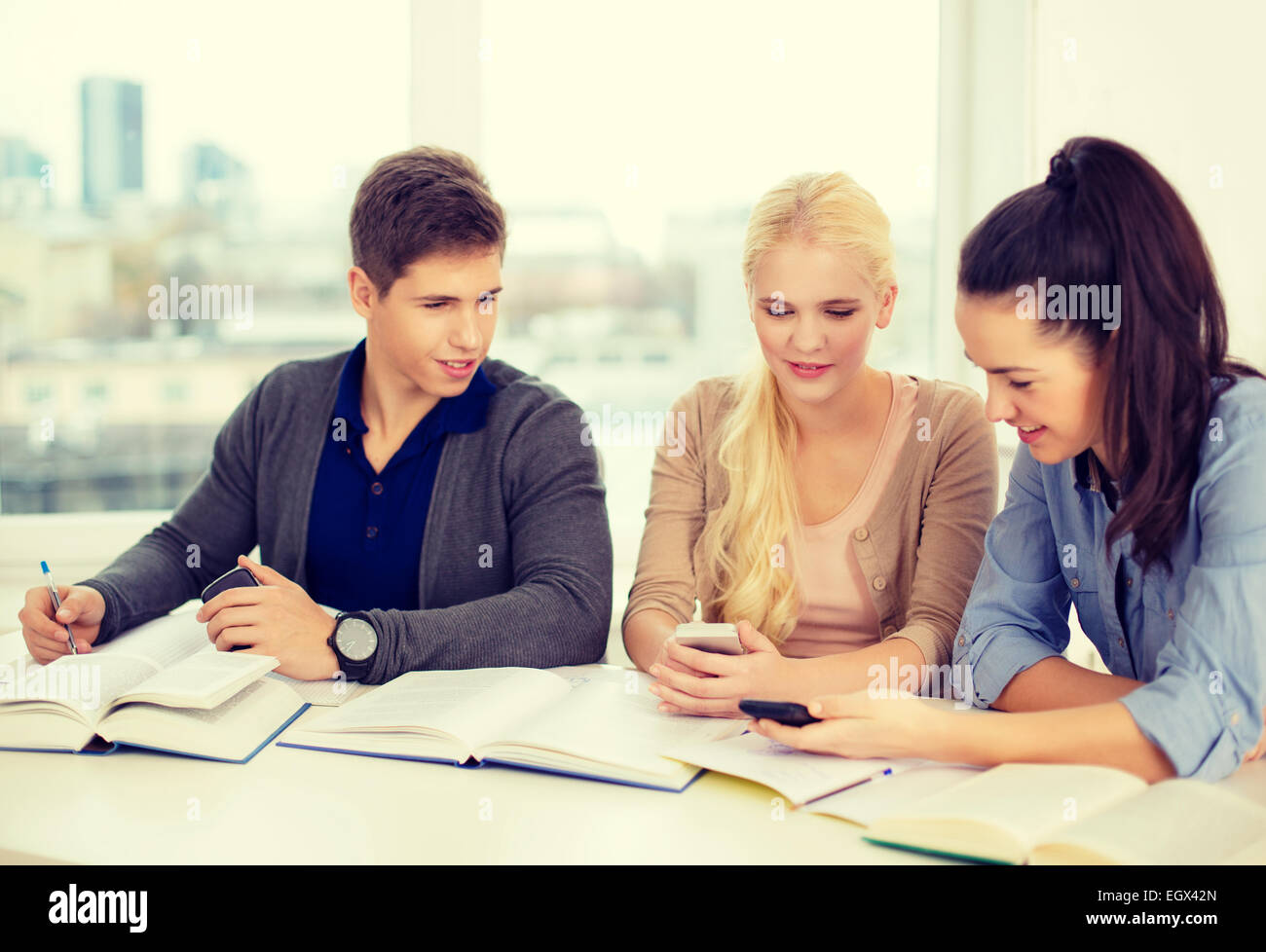 smiling students with notebooks at school Stock Photo - Alamy